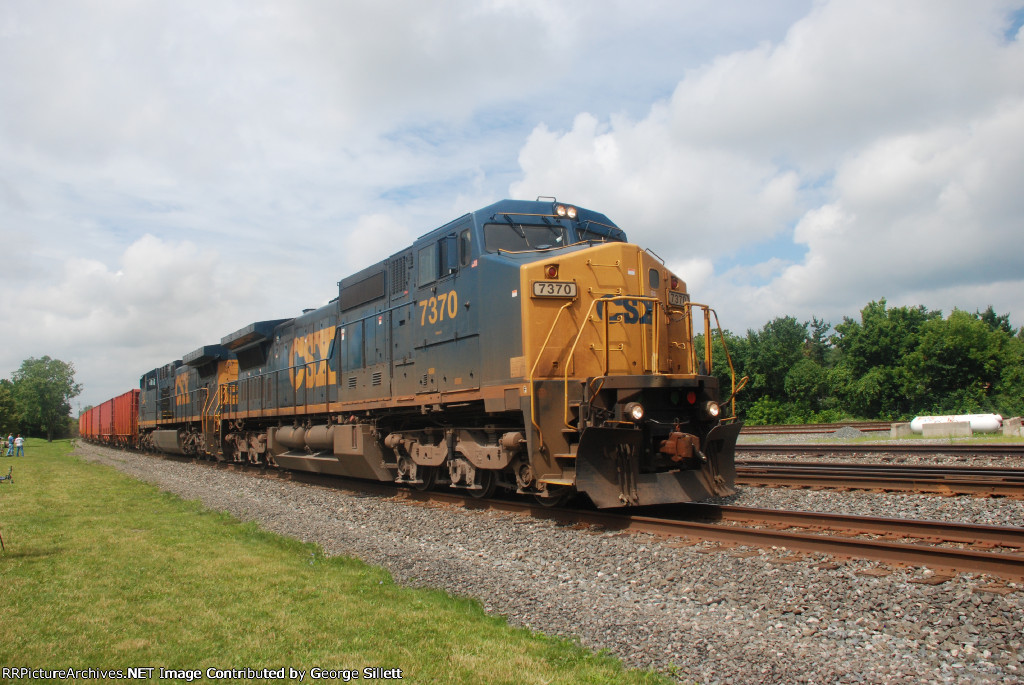 CSX 7370 leads a ballest train east.